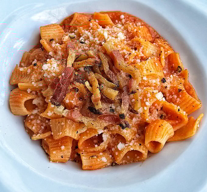 The Rigatoni all'Amatriciana isn't just pasta with sauce—it's a tomatoey, porky symphony that would make an Italian grandmother weep with joy.