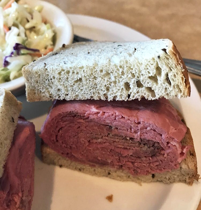 This isn't just a sandwich; it's an architectural marvel of perfectly sliced roast beef nestled between slices of rye bread that deserve their own fan club.