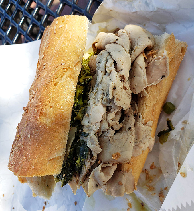 Behold the roast pork sandwich in its natural habitat&mdash;tender meat and vibrant greens nestled in a roll that's achieved bread perfection.