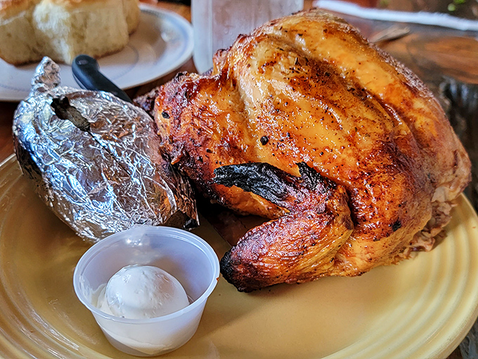 Not your dainty restaurant portion! This golden-brown rotisserie chicken arrives with a baked potato wrapped like a precious gift.