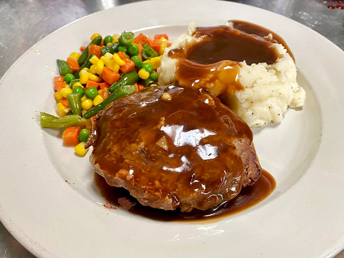 This meatloaf isn't just dinner; it's a time machine to Sunday family meals, complete with gravy that should be classified as a controlled substance.