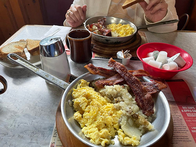 Scrambled eggs that look like fluffy golden clouds, paired with bacon that means business. This plate doesn't need filters to make your mouth water.