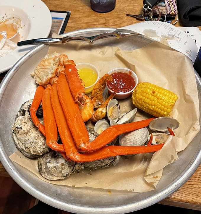 Seafood heaven on a metal tray&mdash;snow crab legs, oysters, and clams with corn on the cob. Neptune himself would approve.