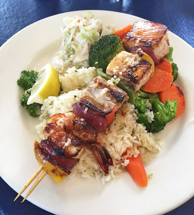 Seafood kabobs so perfectly charred, they could make a vegetarian question their life choices.