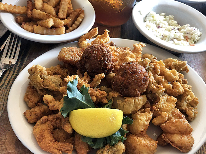 Seafood nirvana achieved! This golden-fried platter with hush puppies is what happens when the catch of the day meets culinary respect. 