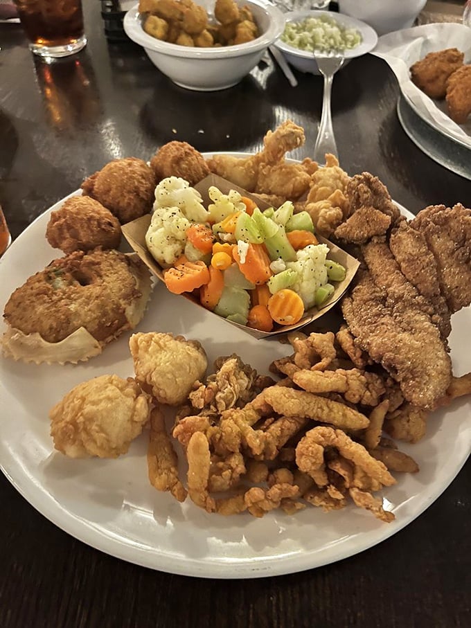 Food architecture at its finest! This seafood platter is the Disneyland of fried goodness, where every golden morsel competes for the title of "best bite."