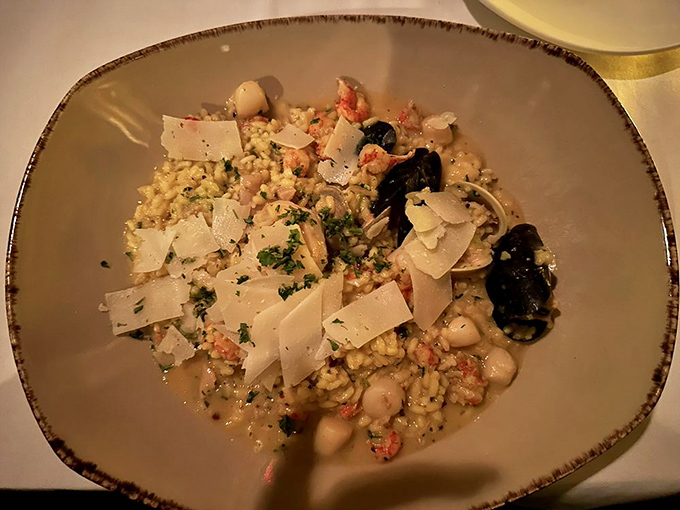 Seafood risotto that would make Neptune himself request seconds &ndash; creamy rice studded with treasures from the sea and topped with delicate cheese shavings.