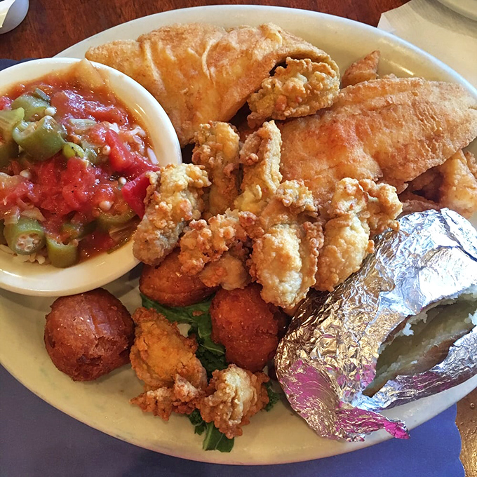 Florida's greatest hits album on a plate: fried seafood, hushpuppies, and stewed tomatoes, all performing in perfect harmony like a Jimmy Buffett concert.