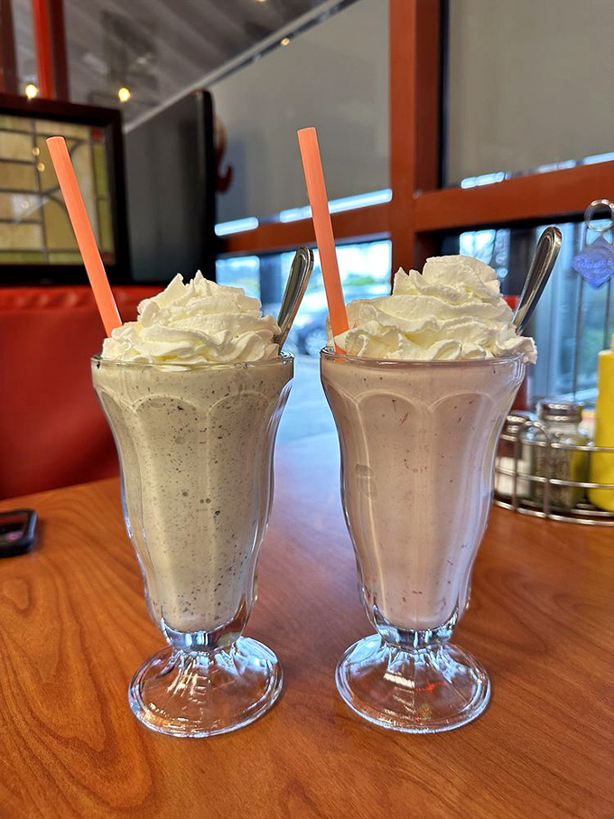 These aren't just milkshakes—they're creamy monuments to indulgence that arrive with their own backup supply in the mixing cup.