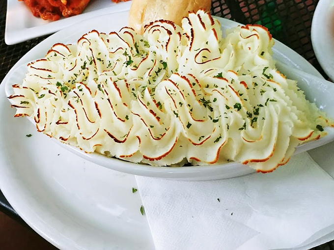 Behold the star attraction – Shepherd's Pie with its perfectly browned potato peaks hiding a savory treasure of seasoned beef and vegetables below.