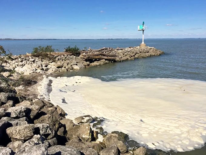 Nature's breakwater creates a perfect pocket of calm, where limestone meets lakewater in a geological conversation millions of years in the making.