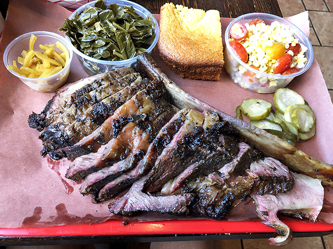 Behold the star of the show: a short rib that would make Fred Flintstone weep with joy, served with sides that refuse to be upstaged.
