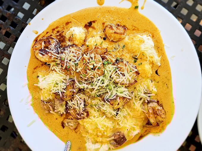 Behold the crown jewel: shrimp and grits that would make a New Orleans chef weep with joy, crowned with perfectly seared shrimp and a sauce worth bottling.