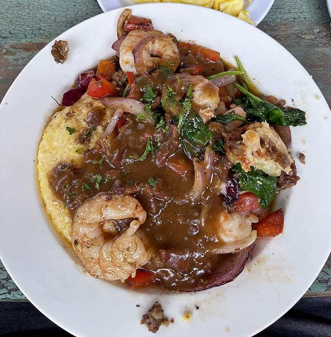Behold the star attraction: shrimp and grits that could make a seafood skeptic weep with joy, swimming in a sauce worth bottling and taking home.