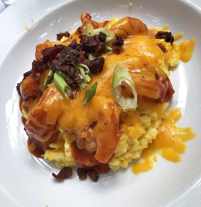 Behold the legendary barbecue shrimp and grits&mdash;a masterpiece of creamy yellow cornmeal topped with plump shrimp, crispy bacon, and scallions. Southern comfort redefined.