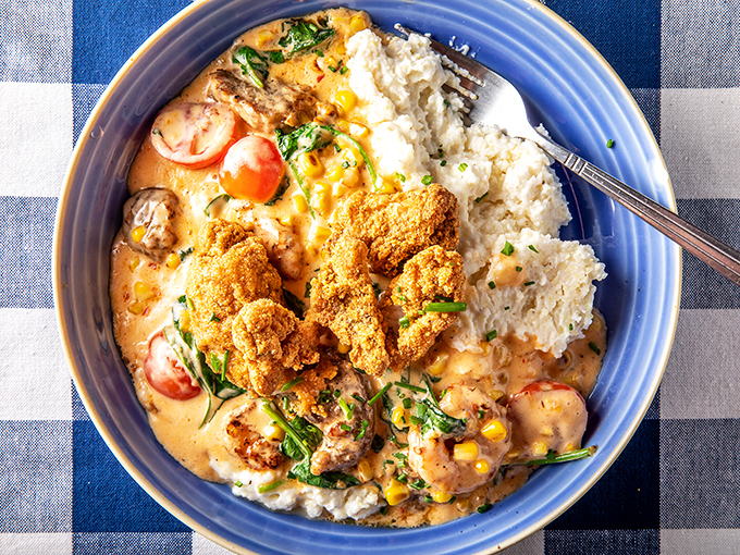 Behold the star attraction: shrimp and grits elevated to an art form, with cornmeal-crusted catfish playing a supporting role that deserves its own standing ovation.