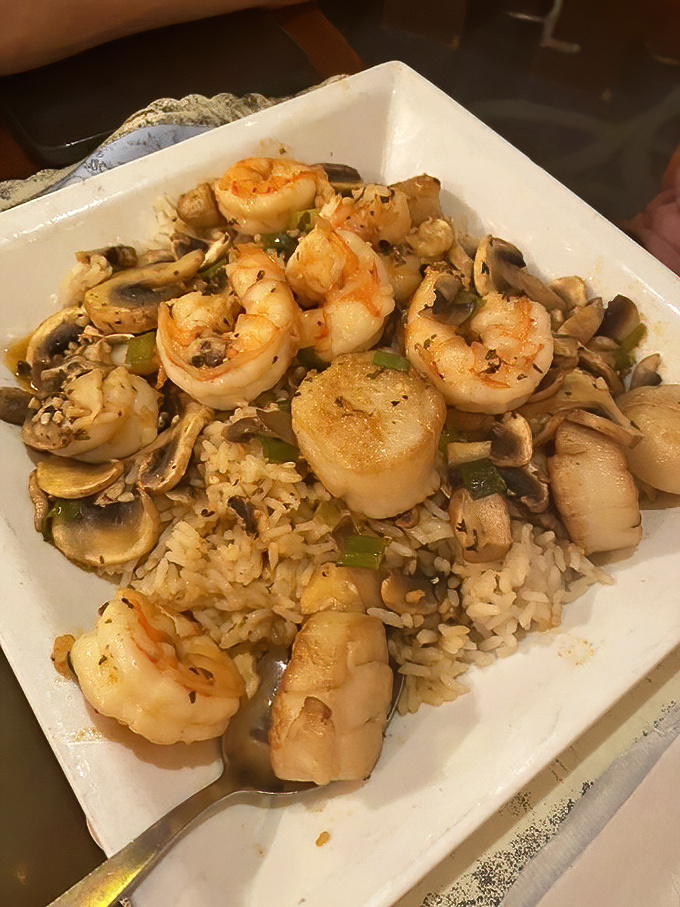 Plump shrimp and tender scallops nestled atop seasoned rice and mushrooms—a plate that makes you wonder why you'd ever eat anything else.