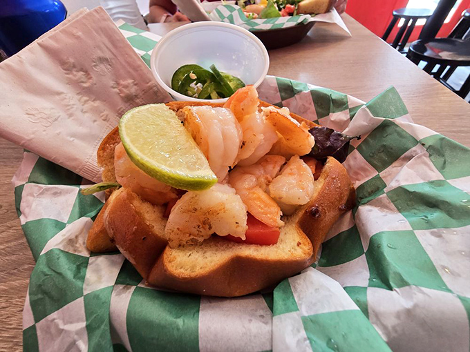 The legendary shrimp roll in all its glory. Florida pink shrimp, key lime, and butter—a holy trinity that makes grown adults consider moving to Key West.