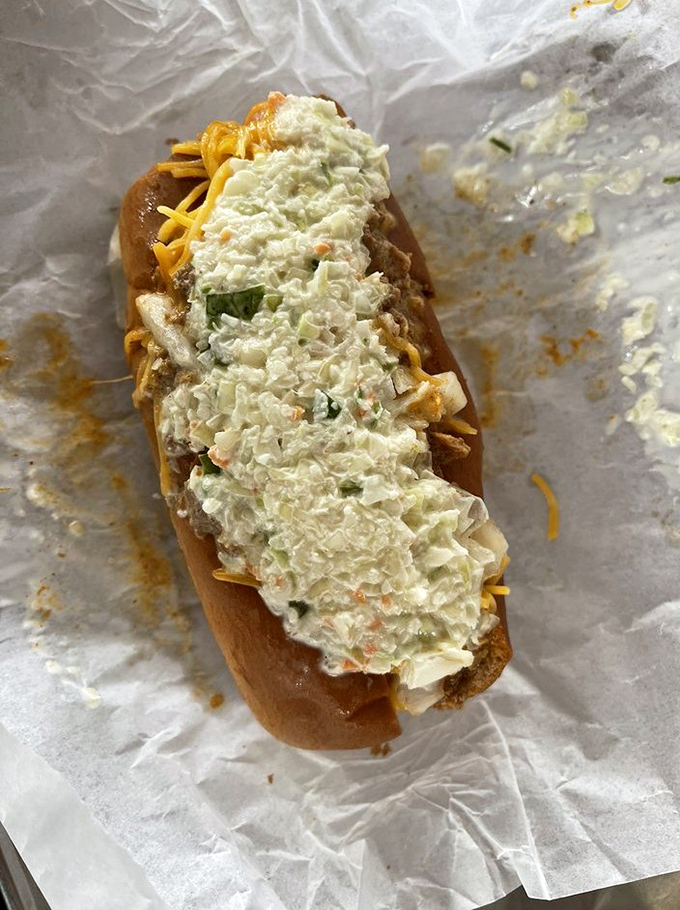 This slaw dog isn't just a meal, it's a Southern handshake &ndash; creamy coleslaw cascading over what lies beneath, a perfect harmony of textures.