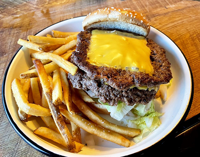 The star of the show: a perfectly smashed burger with crispy edges and melty American cheese. Poetry on a plate, philosophy in a bun. 