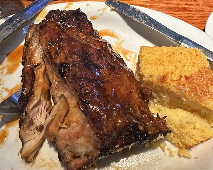 These baby back ribs don't just fall off the bone—they practically leap into your mouth, trailing smoky, sweet evidence of their delicious crime.