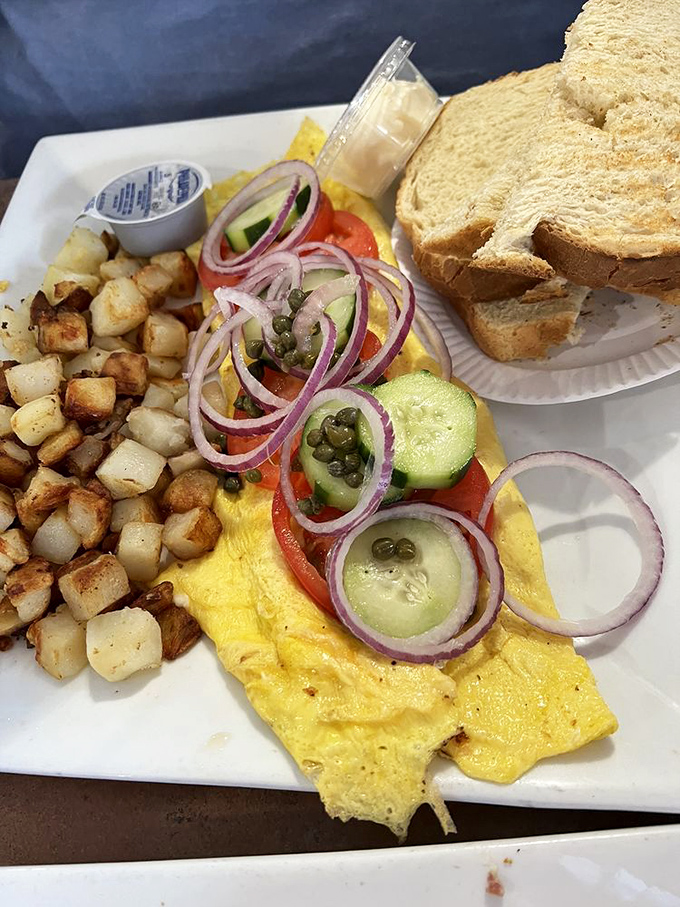 This isn't just an omelet&mdash;it's a seafood festival wrapped in eggs, with those perfectly crispy home fries playing the essential supporting role.