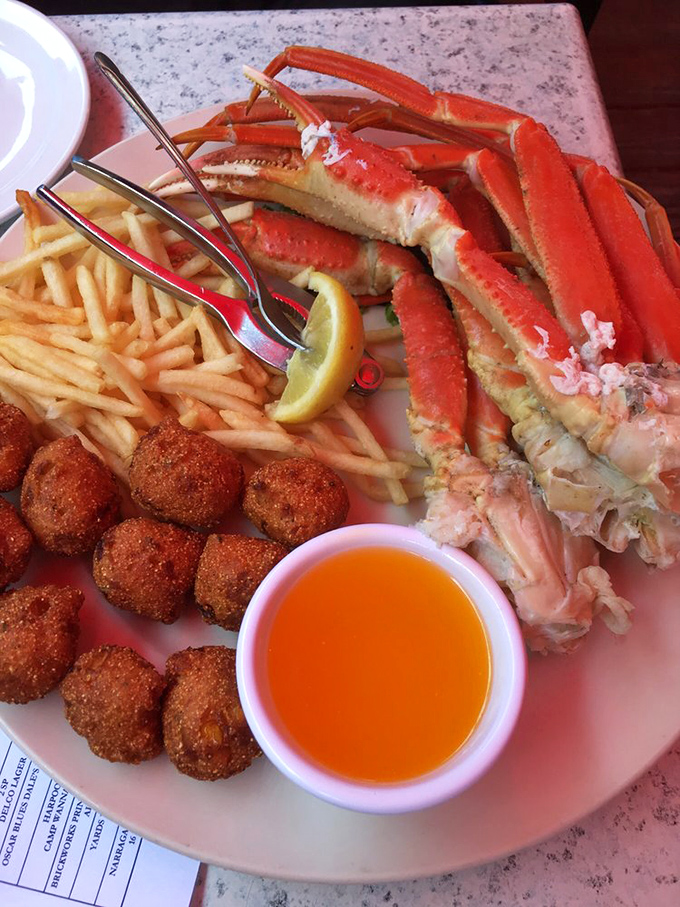 Snow crab legs, hush puppies, and fries&mdash;the holy trinity of seafood indulgence. That little cup of melted butter isn't just a condiment, it's liquid gold.