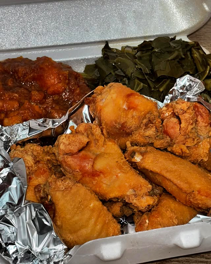 Golden-fried chicken alongside collard greens and candied yams&mdash;the holy trinity of soul food perfection. Comfort on a styrofoam throne.