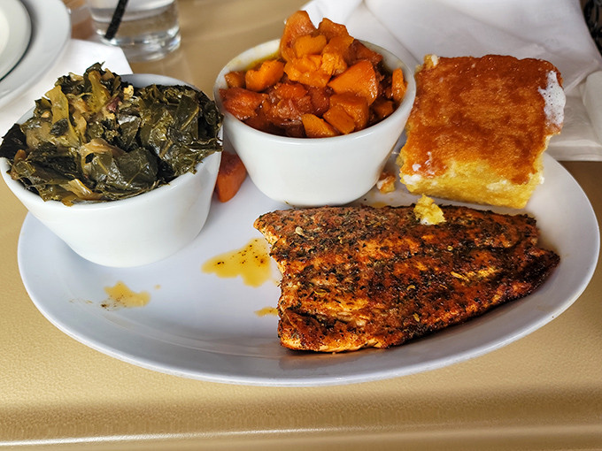 This isn't just a plate&mdash;it's a Southern symphony: perfectly seasoned fish, collard greens singing with flavor, and candied yams that could make your grandma jealous.