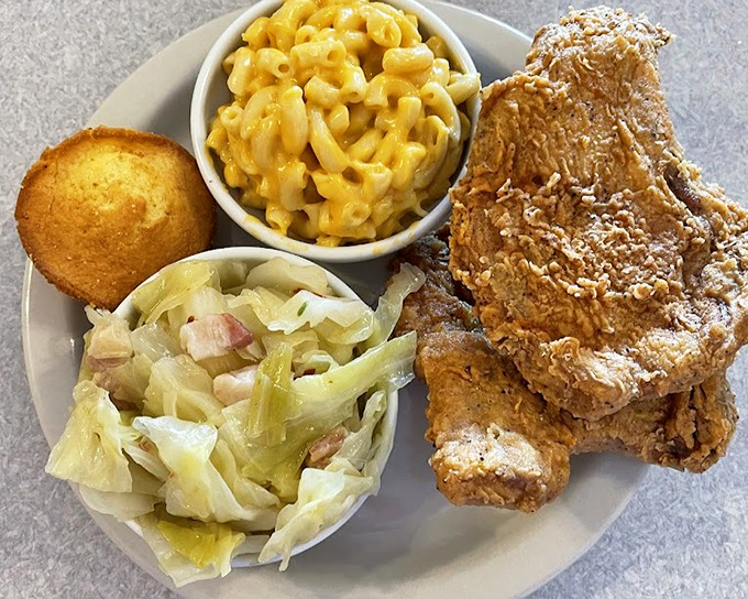 Golden-brown fried chicken that shatters with each bite, paired with mac and cheese that could make a grandmother weep with pride.