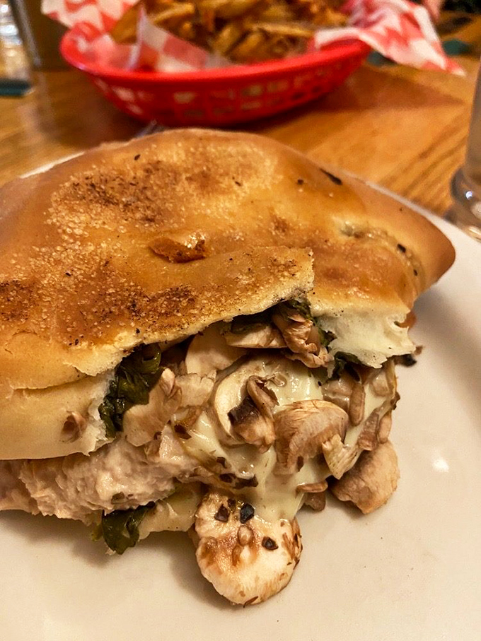Behold the sandwich that could launch ships: melty cheese, earthy mushrooms, and vibrant greens nestled between perfectly toasted bread. Comfort food elevated.