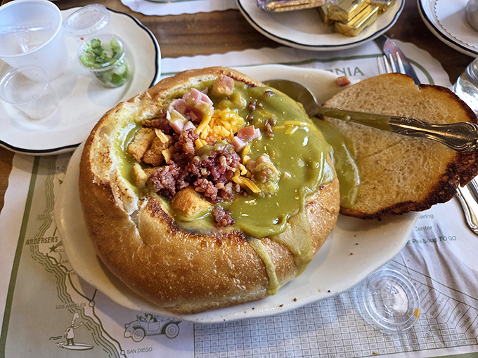 Split pea soup served in a bread bowl: where comfort food meets edible dishware. The vibrant green hue might raise eyebrows, but the flavor will raise spirits.