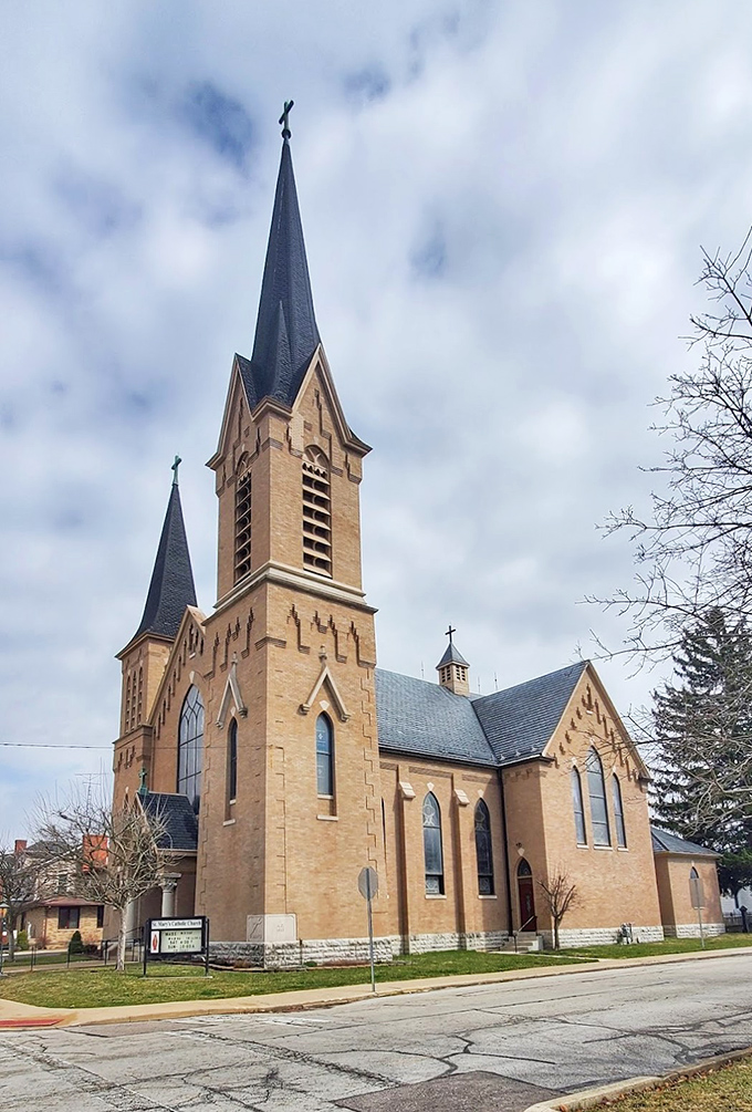St. Mary's Catholic Church reaches skyward with its impressive spires, a spiritual landmark that's been gathering the faithful for generations.