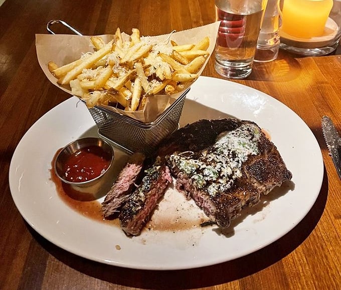 A perfectly medium-rare steak with blue cheese crust alongside parmesan fries &ndash; proof that sometimes the simplest pleasures are the most profound.