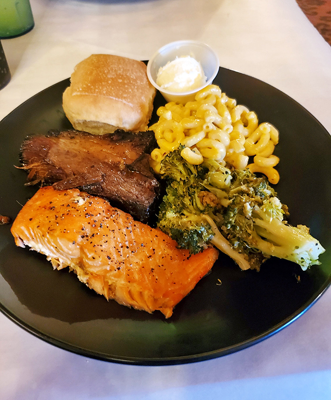 Salmon that glistens like a sunset, brisket with a smoke ring to make pitmasters weep, and sides that refuse to be afterthoughts. This plate means business.