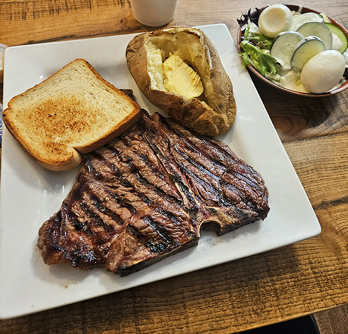 This isn't just a steak; it's a masterpiece of simplicity—perfectly charred exterior, buttery potato, and a salad that politely knows its supporting role.