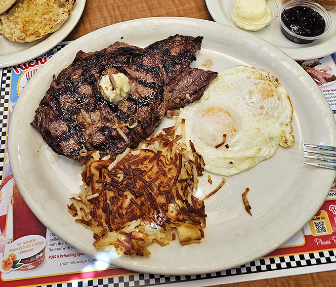 That steak has grill marks so perfect they could be in the Smithsonian. The eggs and hash browns are just showing off at this point.