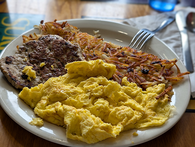 Scrambled eggs so fluffy they might float away if not anchored by that perfectly seasoned steak. Those hash browns deserve their own fan club.