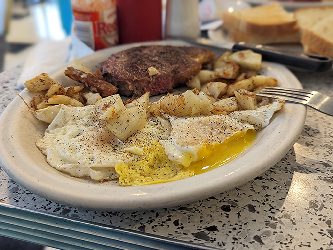 The star of the show: perfectly seared steak alongside eggs with yolks so golden they could fund your retirement. Pure breakfast bliss.