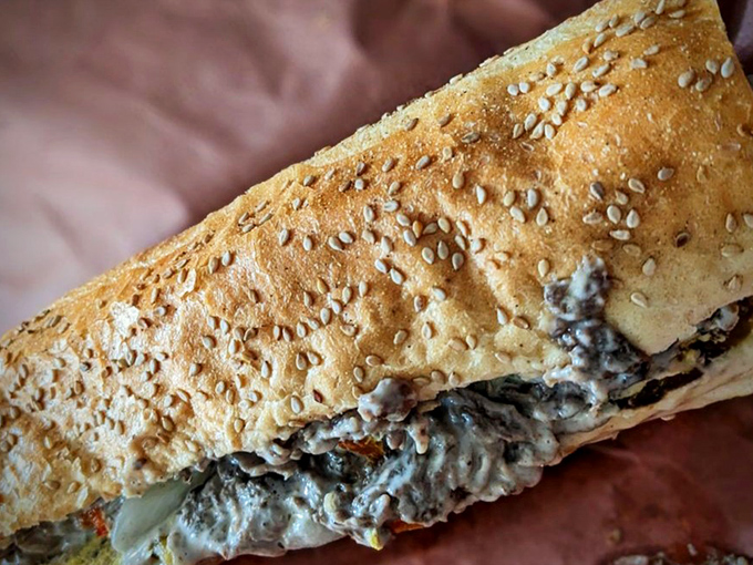This isn’t just lunch; it’s a steak sandwich masterpiece, with sesame-crusted bread struggling to contain Philadelphia’s best-kept secret.