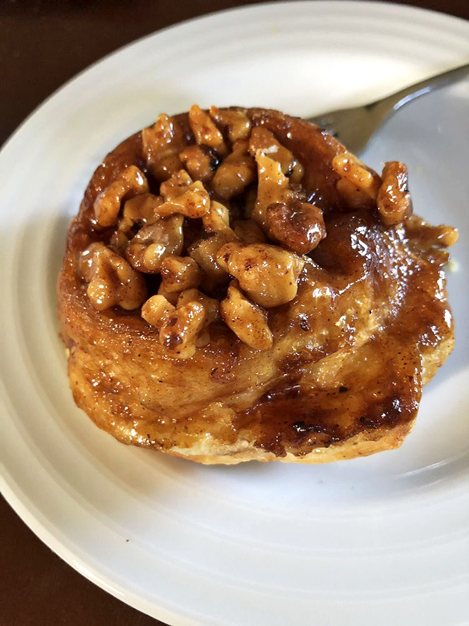 Behold the sticky bun that launched a thousand early morning alarms. This caramelized, walnut-topped masterpiece is worth every minute of the wait.