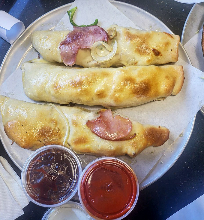 Behold the golden-brown glory! These ham-topped breadsticks aren't just food; they're edible treasure chests with melted cheese as the bounty.