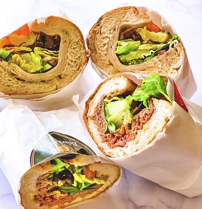 A quartet of Mickey's subs in their natural habitat &ndash; wrapped in paper, bursting with fillings, and moments away from causing involuntary food moans.