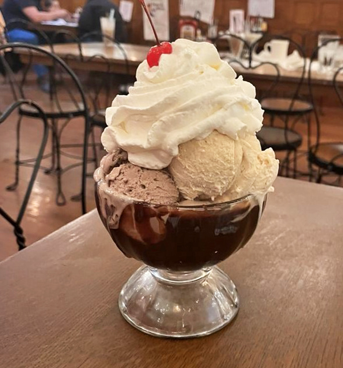 This isn't just a sundae &ndash; it's architecture in a glass, with scoops of ice cream balanced precariously above hot fudge like a delicious game of Jenga.
