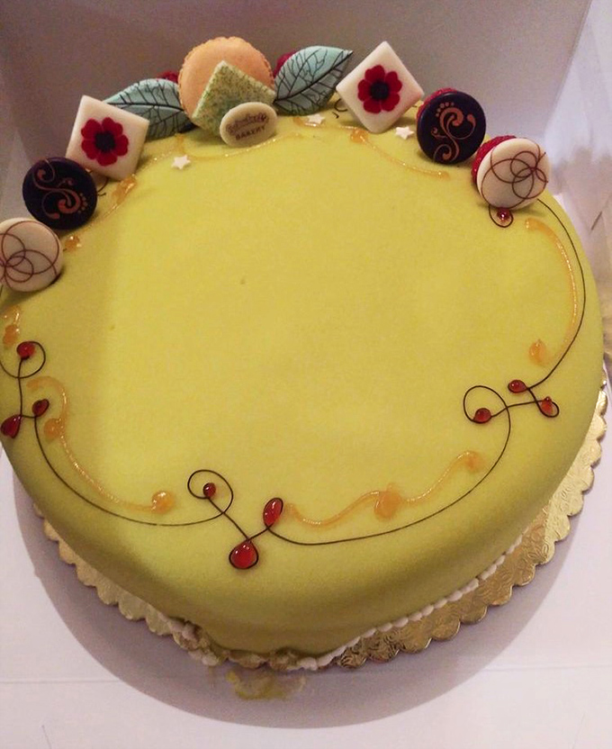 Behold the Swedish Princess Cake in all its green marzipan glory, crowned with delicate decorative flourishes.