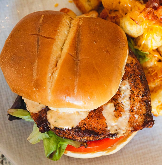 This isn't just a sandwich; it's seafood architecture&mdash;perfectly seasoned fish on a pillowy bun that makes you wonder why you'd ever eat anything else.