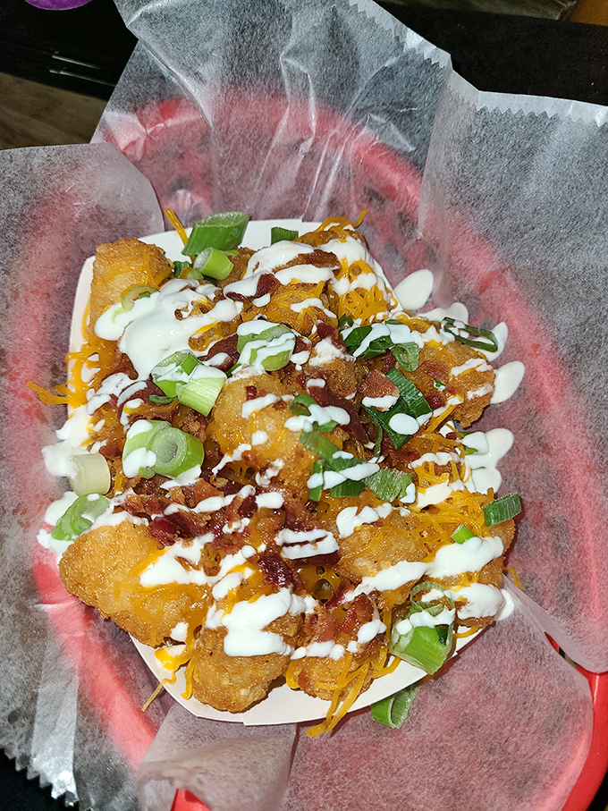 Golden tots transformed into edible art &ndash; crispy perfection topped with bacon, cheese, and pure happiness.