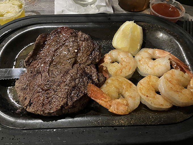 Surf and turf perfection on a sizzling platter. That steak isn't just cooked&mdash;it's been sweet-talked to tenderness alongside plump, succulent shrimp.