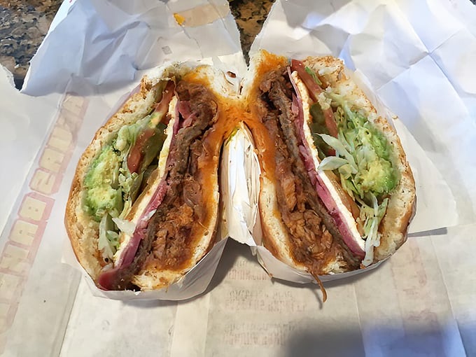 The legendary Torta Cubana in all its glory &ndash; a skyscraper of meats, cheese, and veggies that requires both hands, several napkins, and absolutely zero shame.
