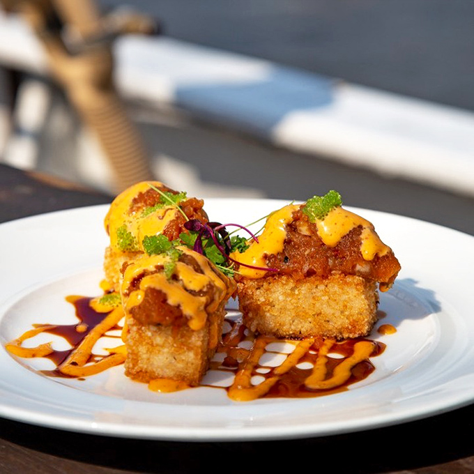 These aren't your college dorm room tater tots. Crispy, golden bites elevated with vibrant sauces that make you wonder why all finger food isn't this sophisticated.